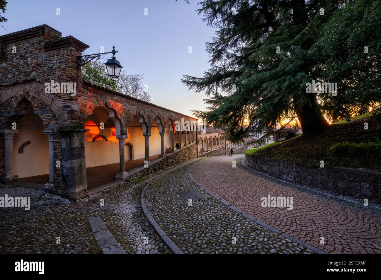 Beautiful Italian cityscape at sunset. Antique alley and portico with ...