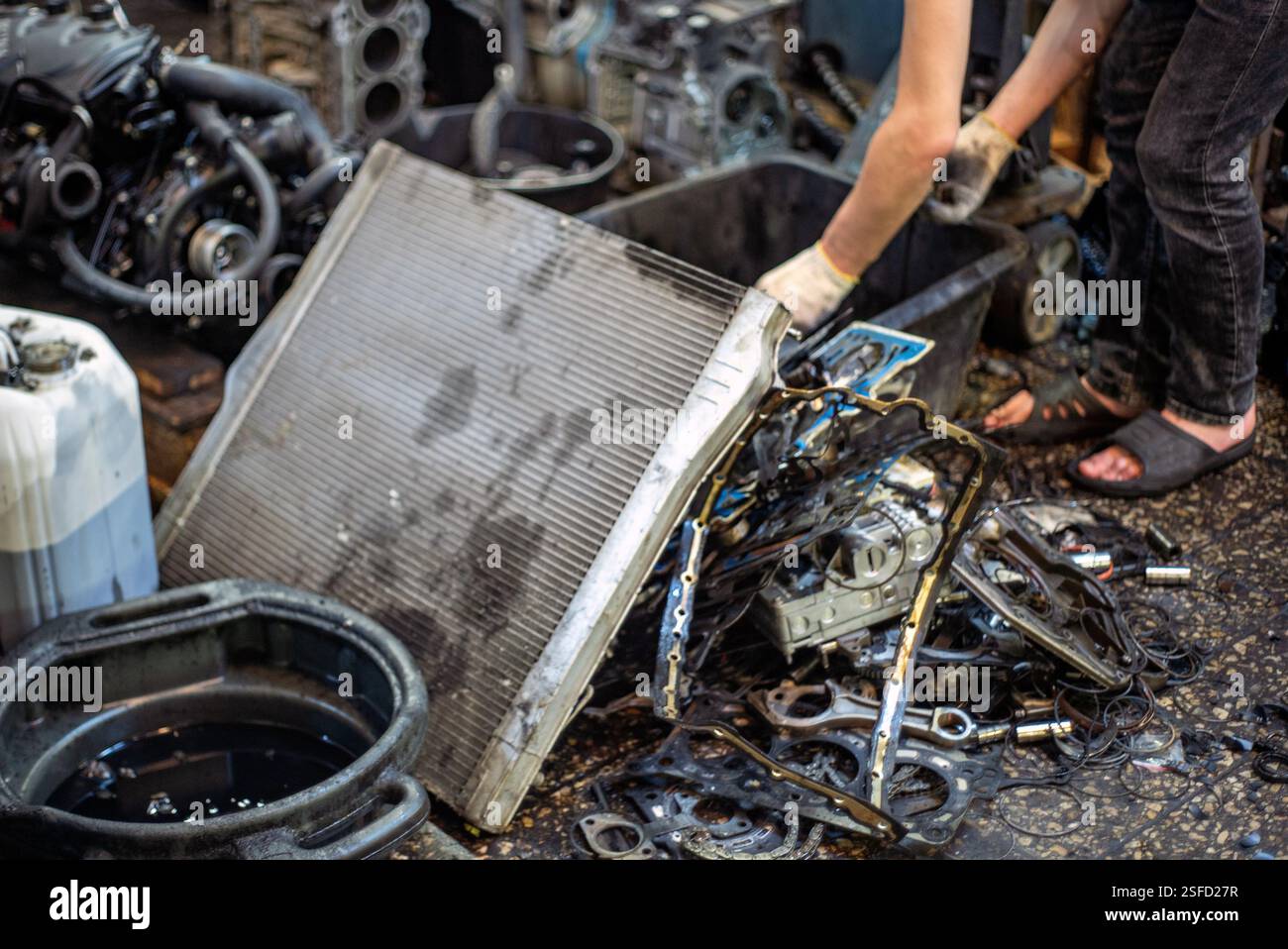 collection of vehicle parts scattered on the messy garage floor and ...