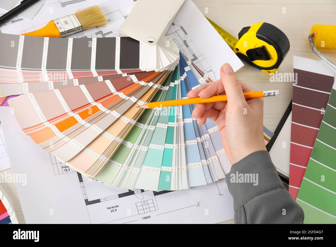 Designer with color selection chart working at table, closeup Stock ...