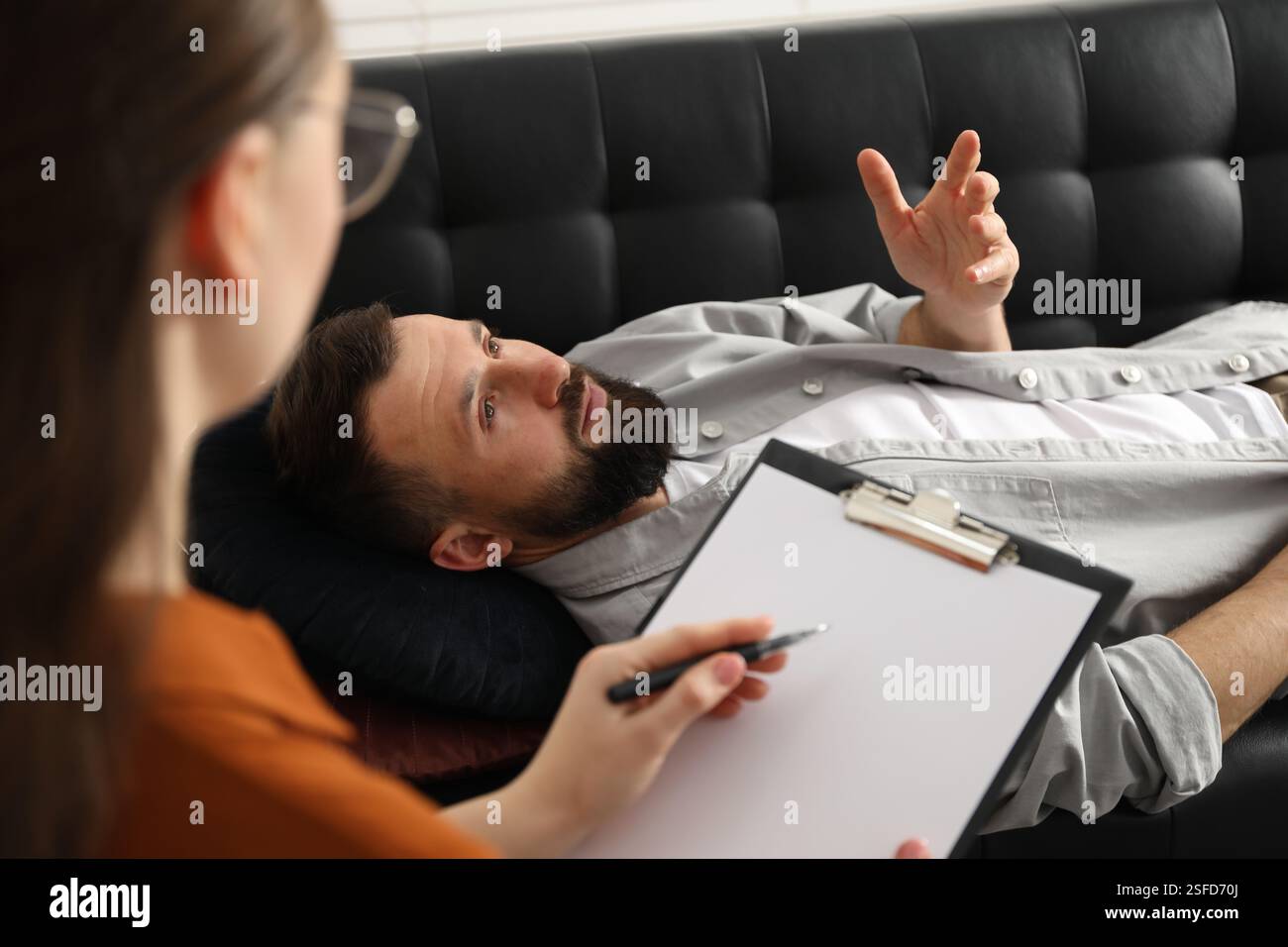 Psychologist working with patient during hypnosis session indoors Stock ...