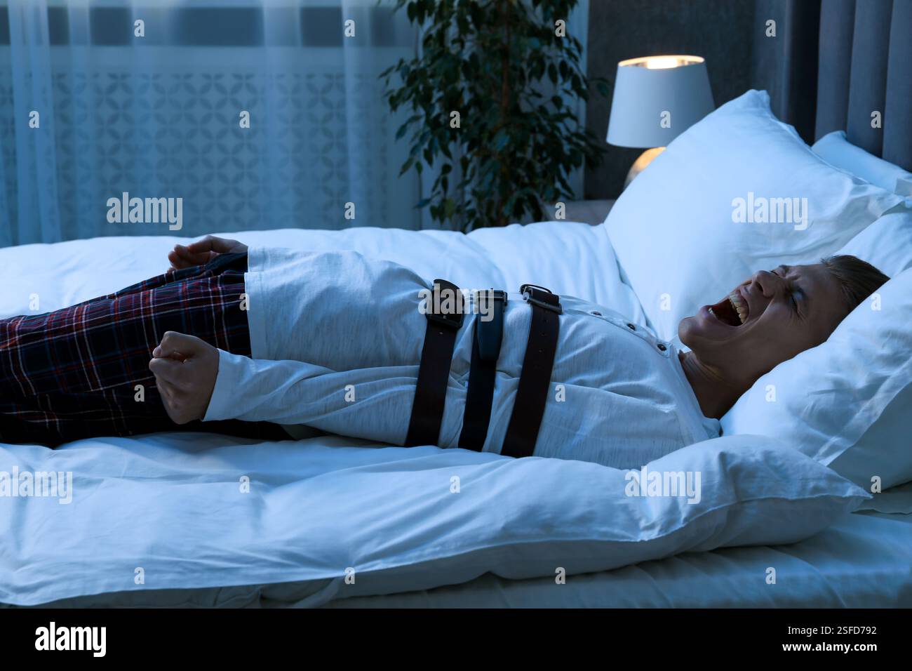 Man in sleepwalking condition screaming on bed Stock Photo - Alamy