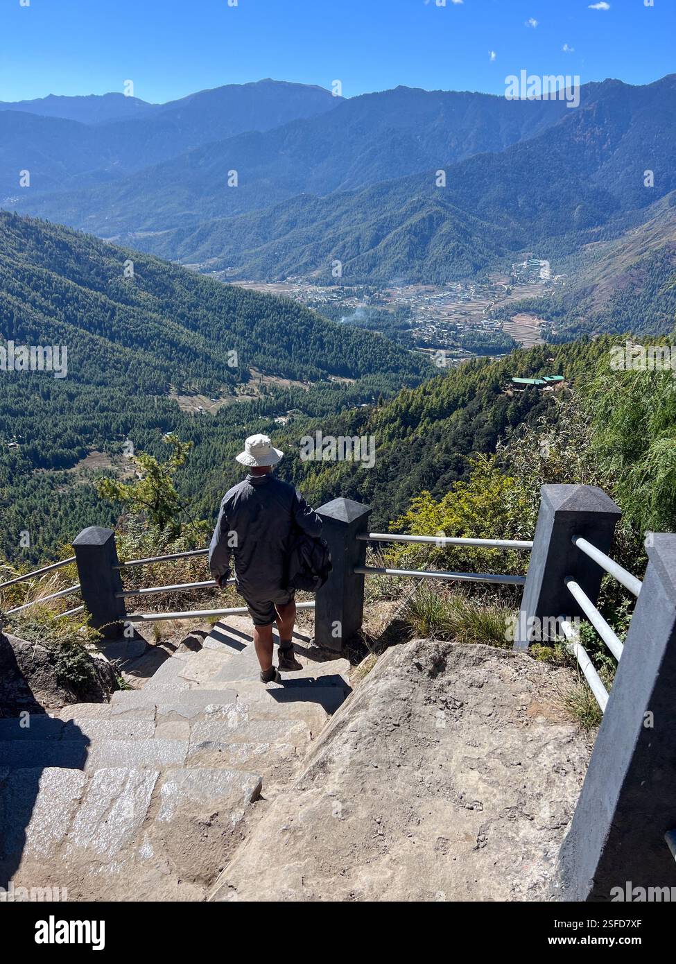 Man walking down steps on a hike to Tiger's Nest Monastery (Paro ...