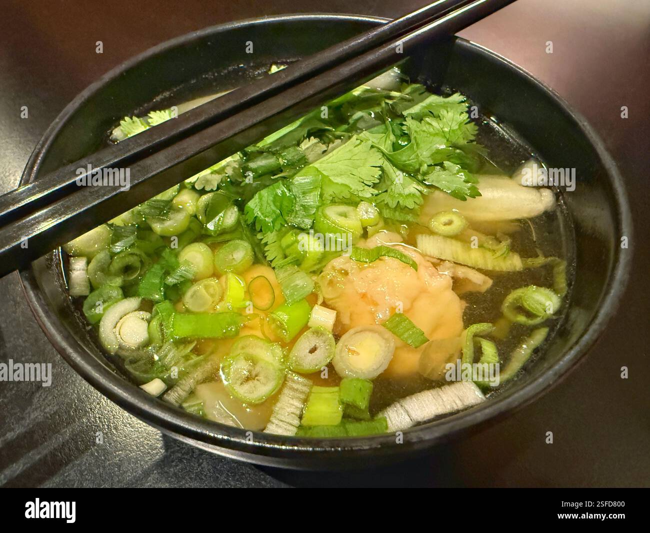 Close-up of a bowl of Asian Won Ton soup with pak choi, coriander and ...