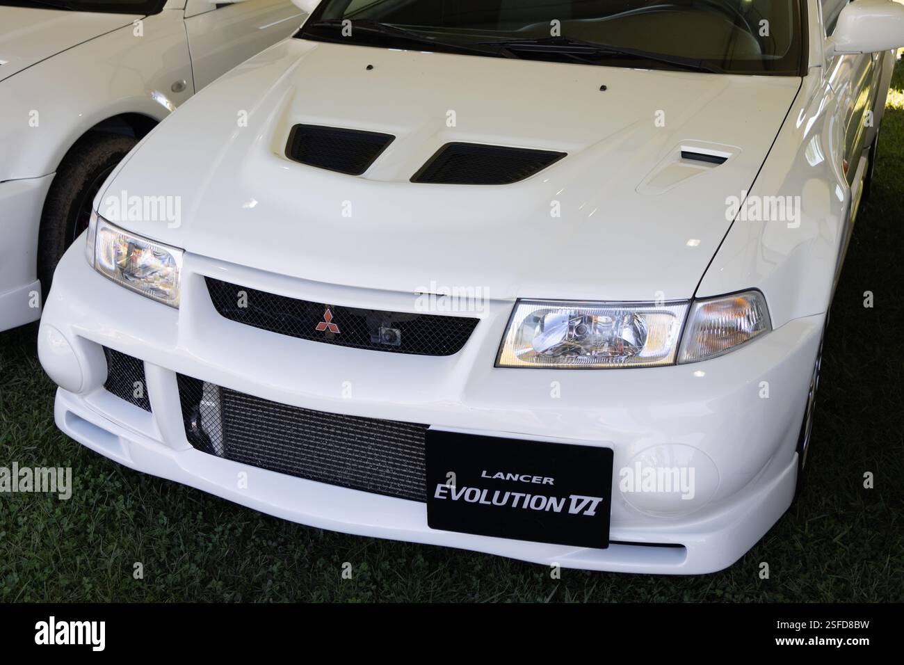 Close up of a white mitsubishi lancer evolution vi, highlighting its ...