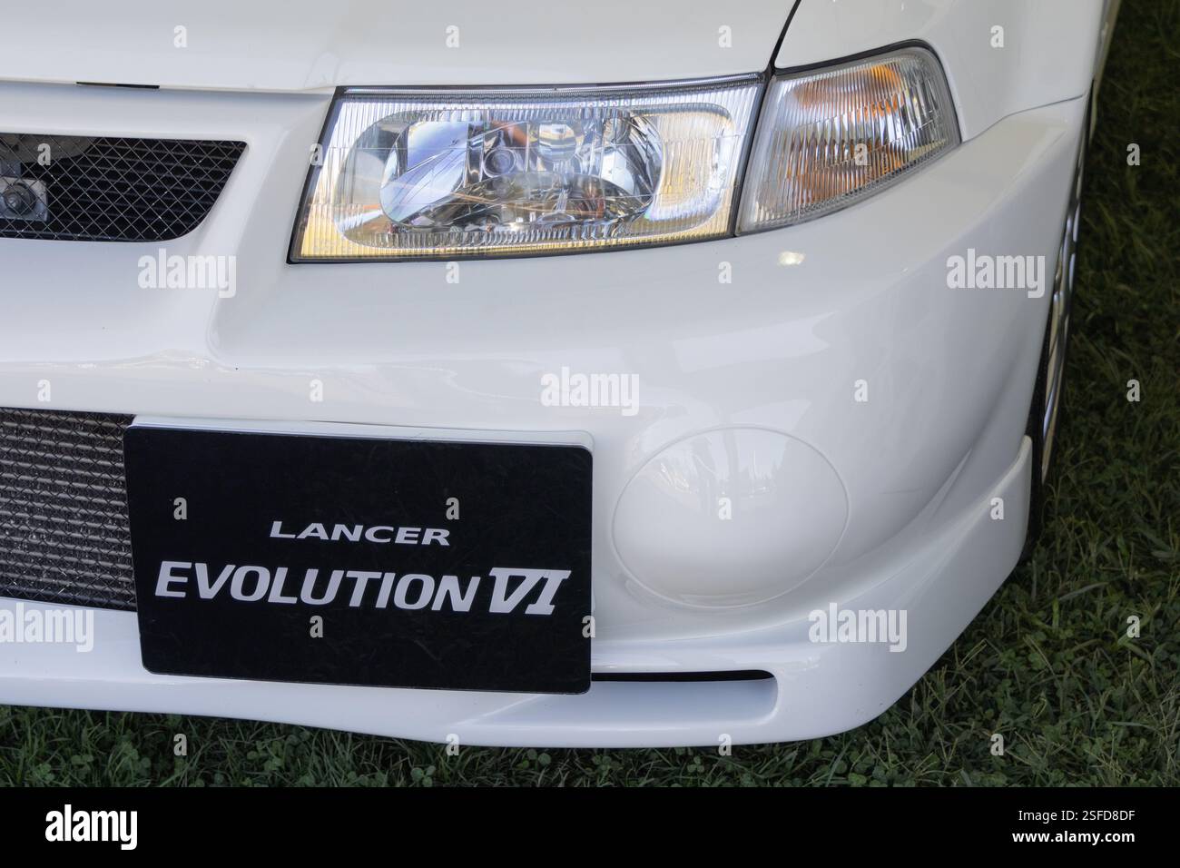 Close up of the front of a white mitsubishi lancer evolution vi ...