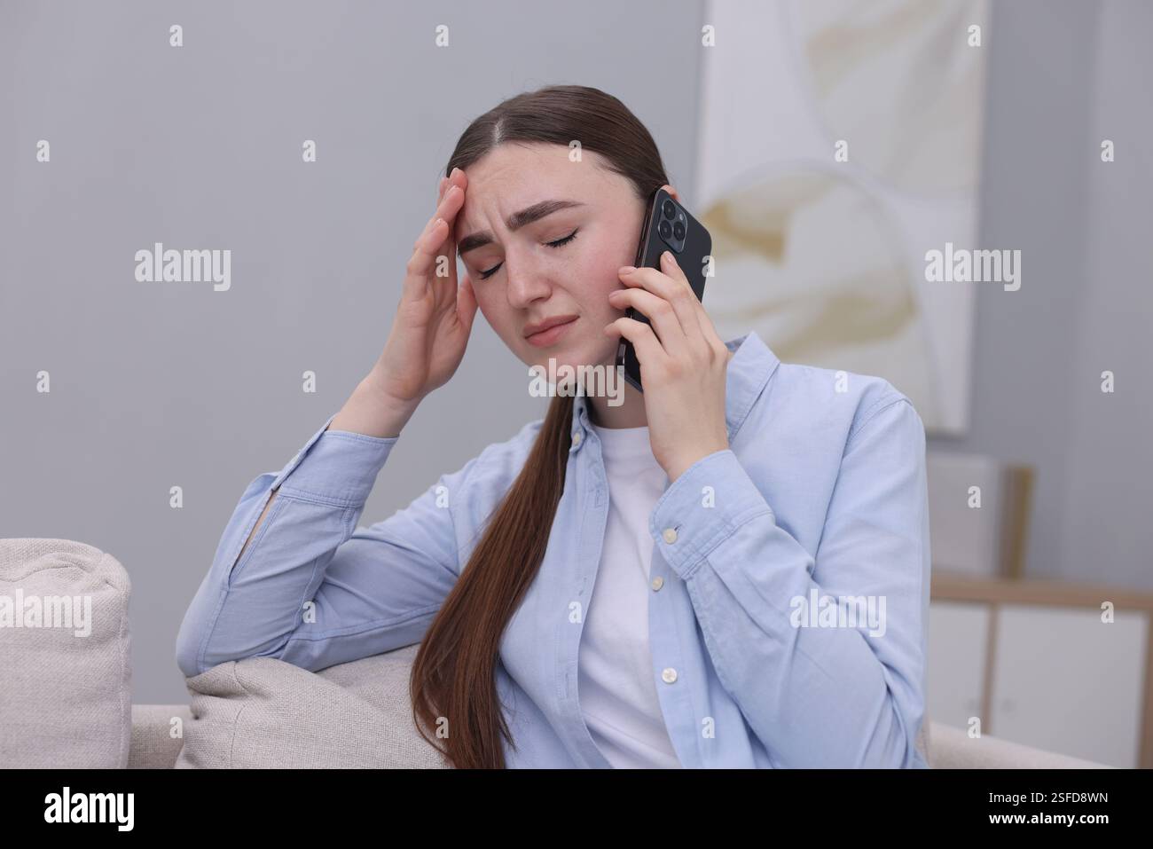 Stressed woman calling hotline for mental health help at home Stock ...
