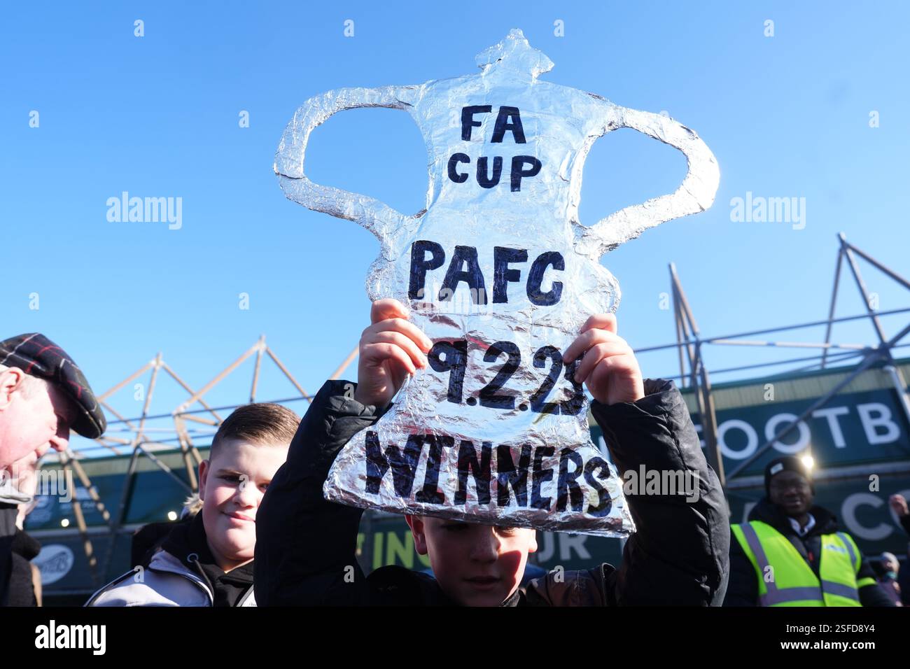 A Plymouth Argyle fan holding a tin foil trophy outside the ground ...