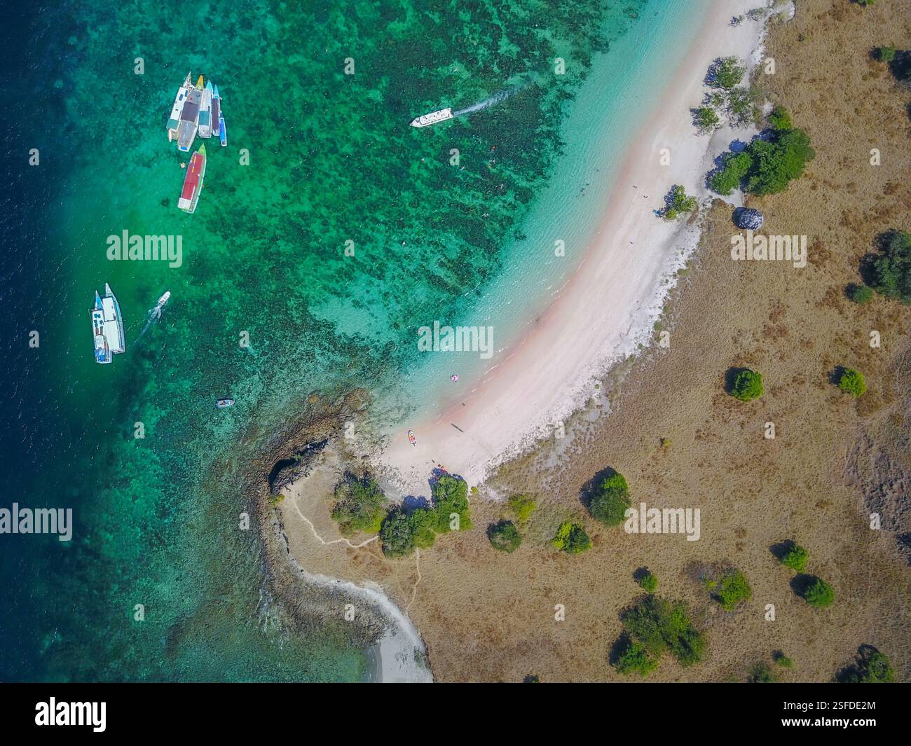 Aerial view of boats sailing by Pink Beach (Pantai Merah), Komodo ...