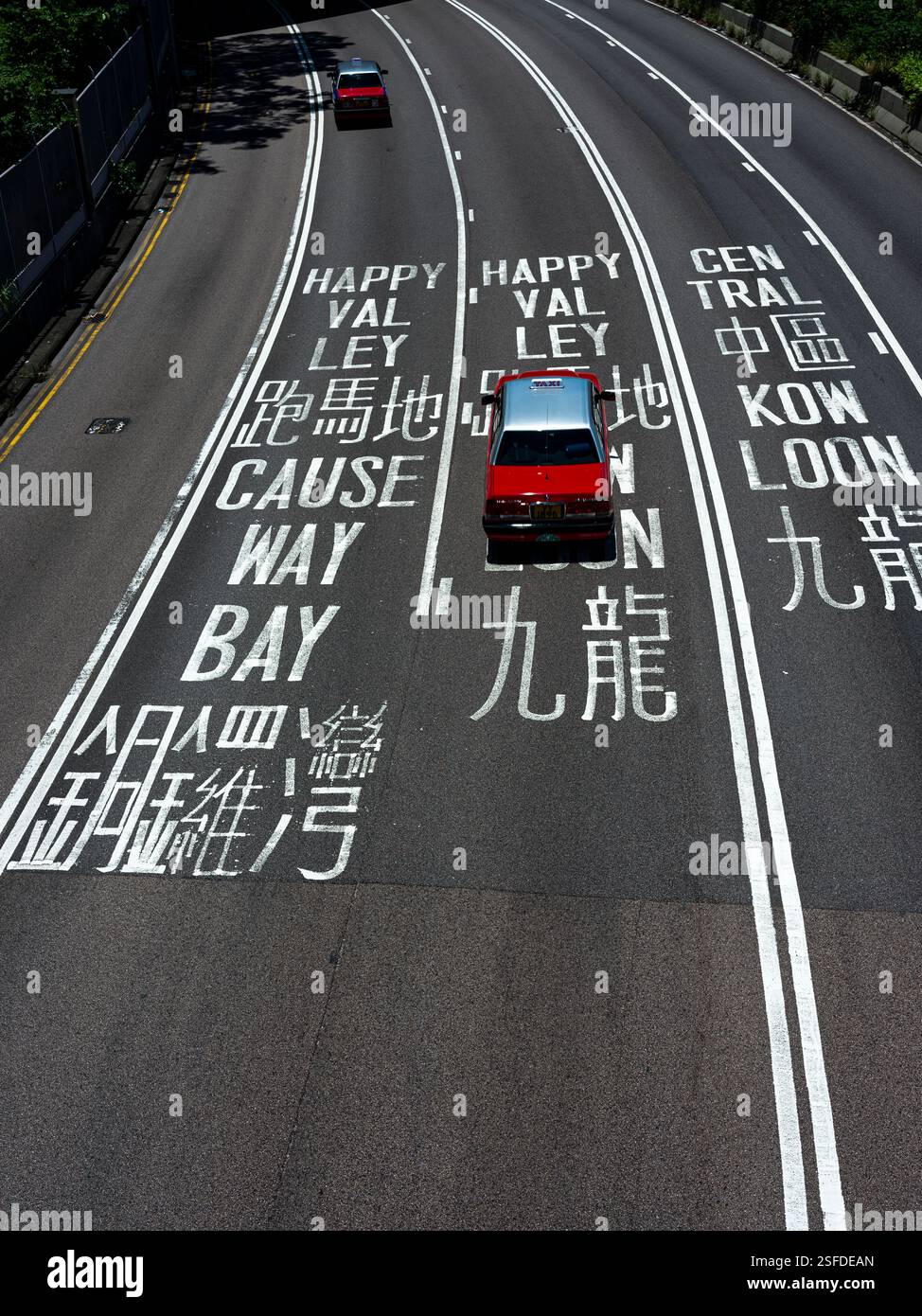 Hong Kong taxis from above with the road signs in English and Cantonese ...