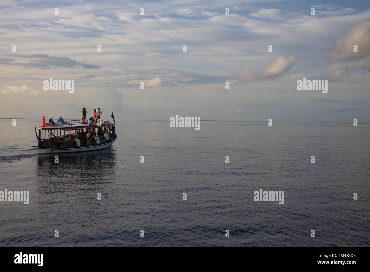people on roof of boat cruising during sunset Stock Photo - Alamy