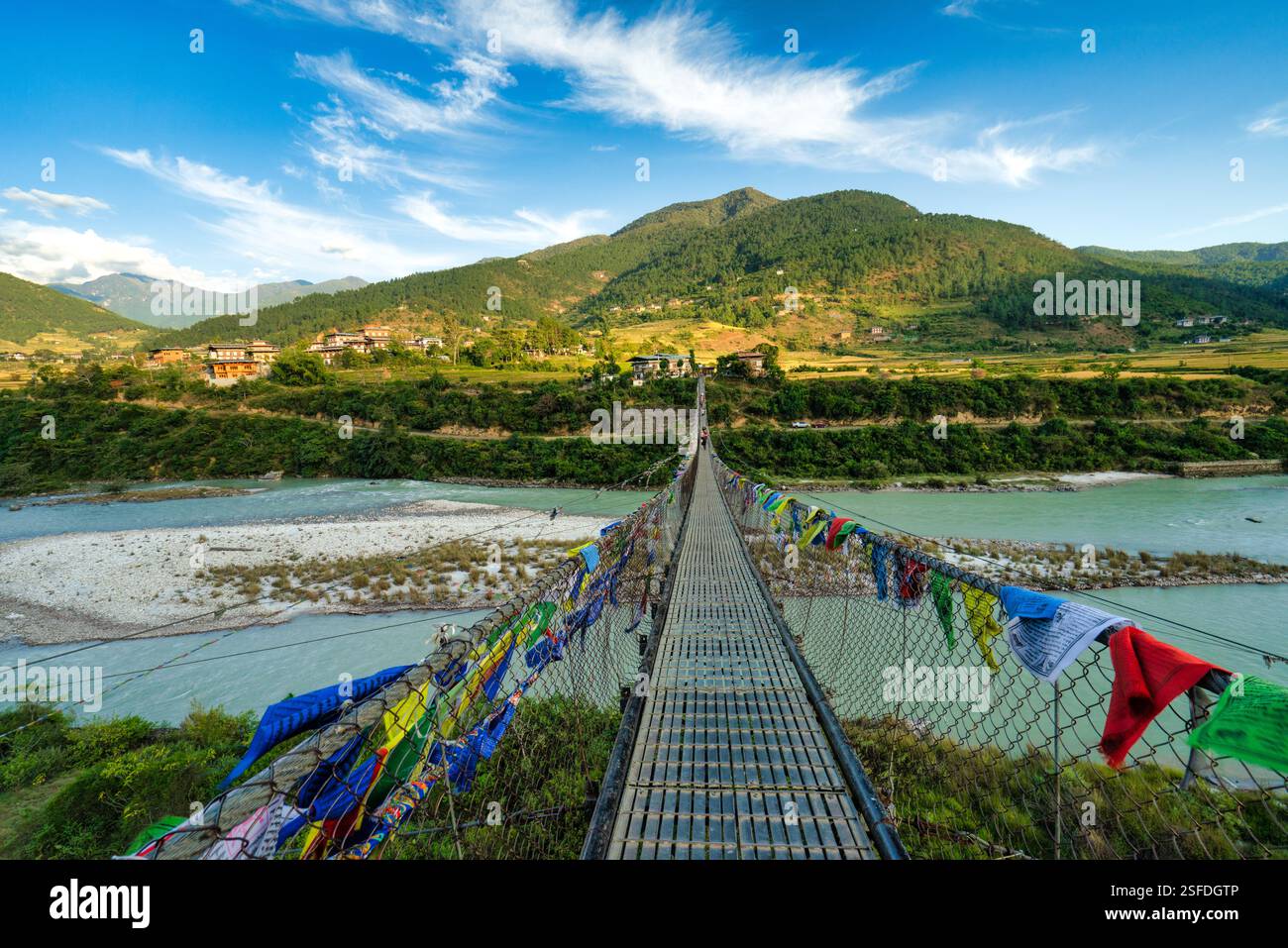 People crossing the pedestrian suspension Bridge decorated with prayer ...