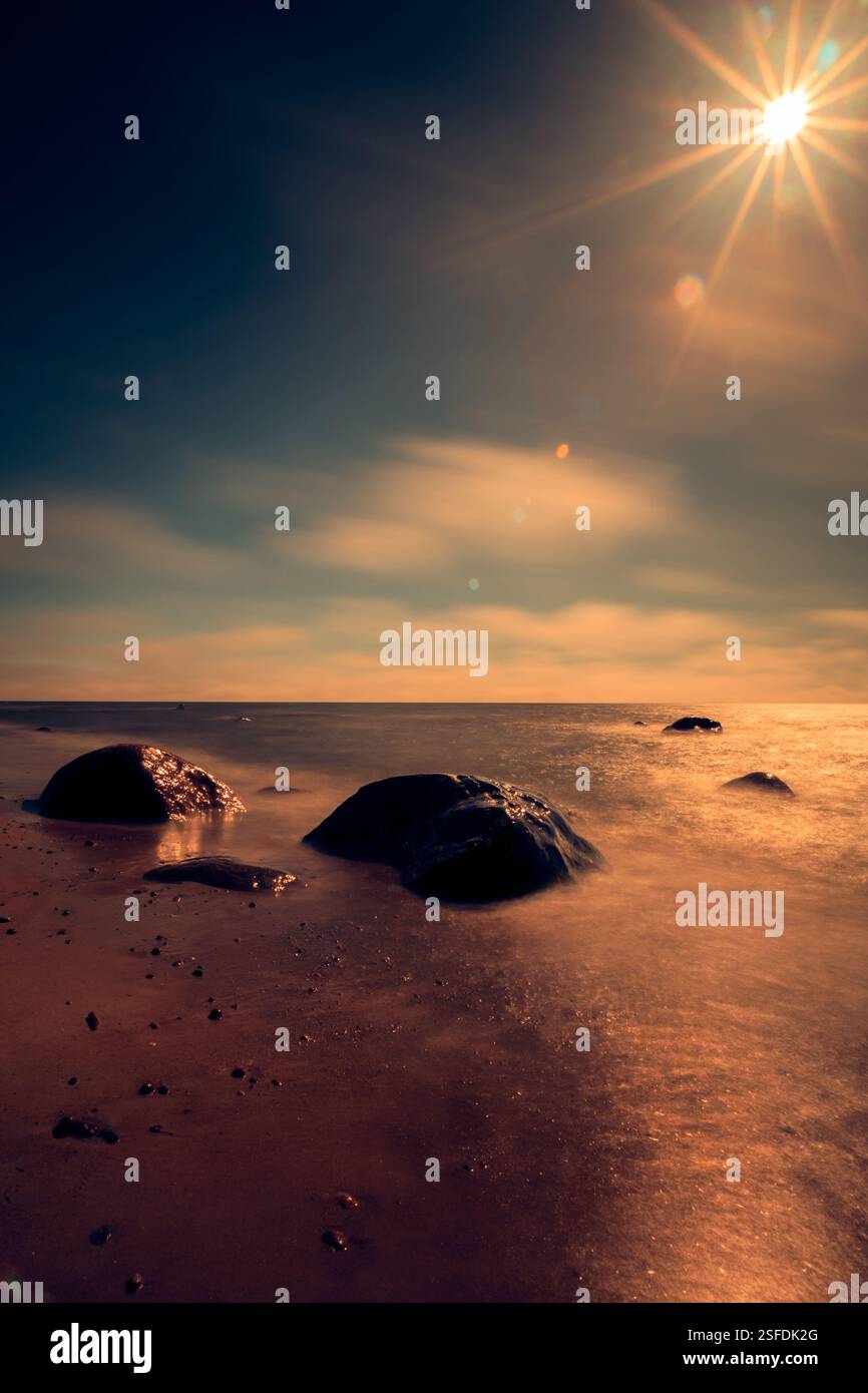 Sunburst over a sandy beach along the Baltic sea, Lithuania Stock Photo ...