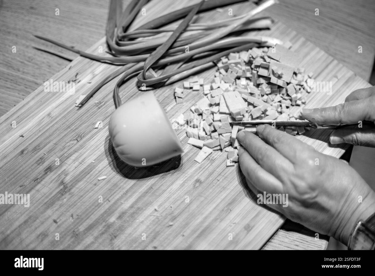 female hands chopping salami and onion, in black and white Stock Photo ...