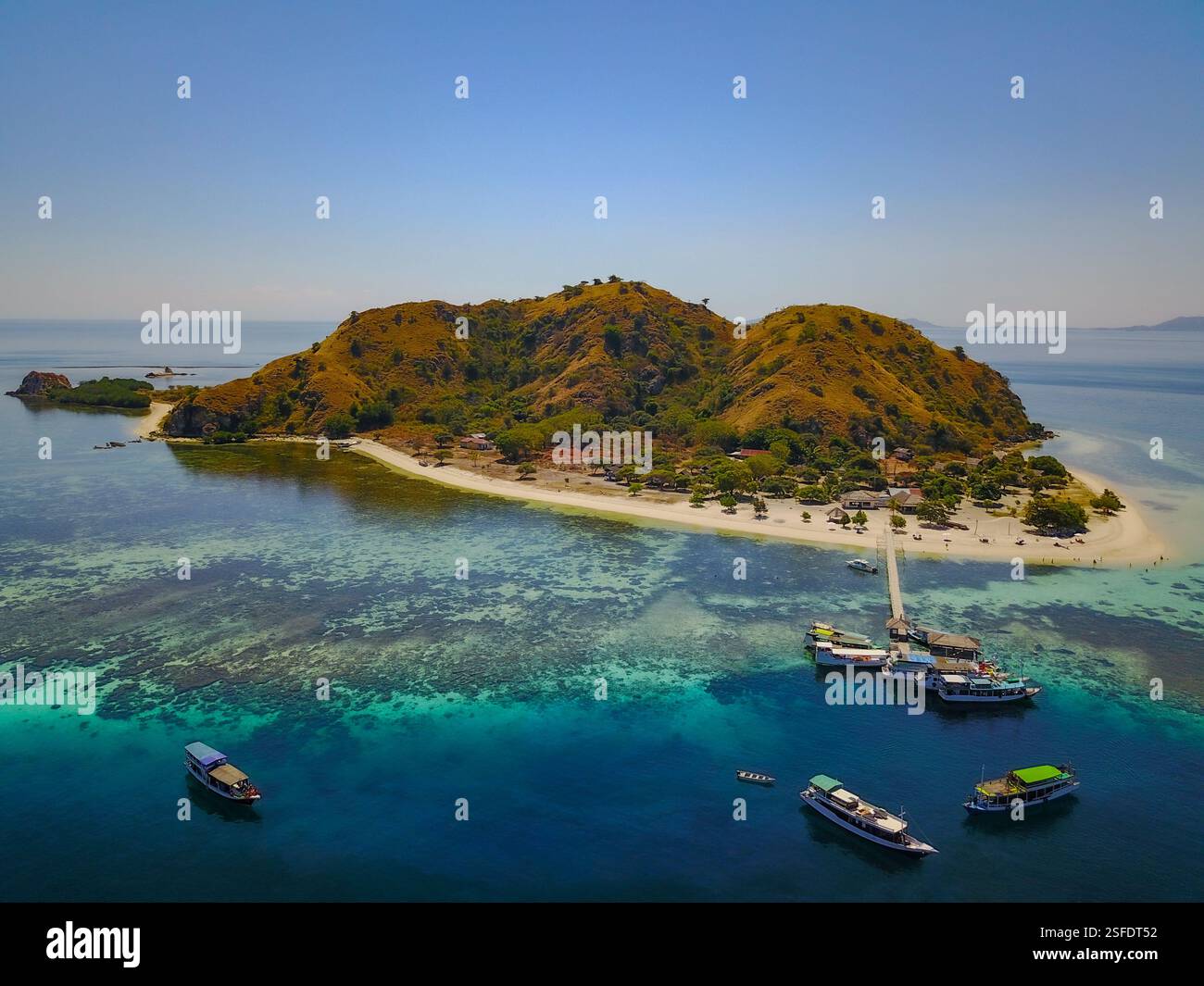 Aerial view of Tourist boats moored off the coast of Kelor island ...