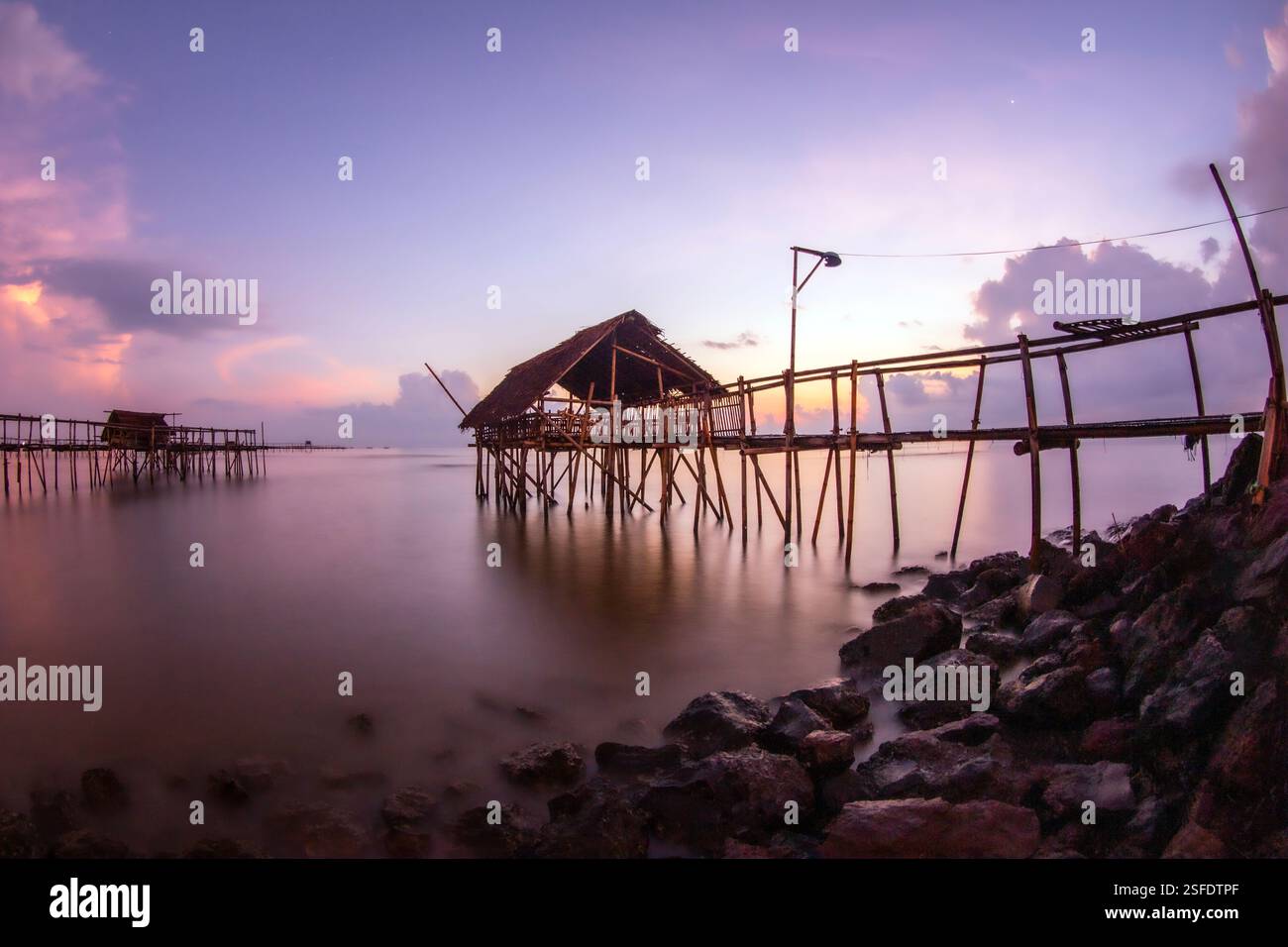 Bamboo pier on a beach at sunrise, Tanjung Kait, Mauk District ...