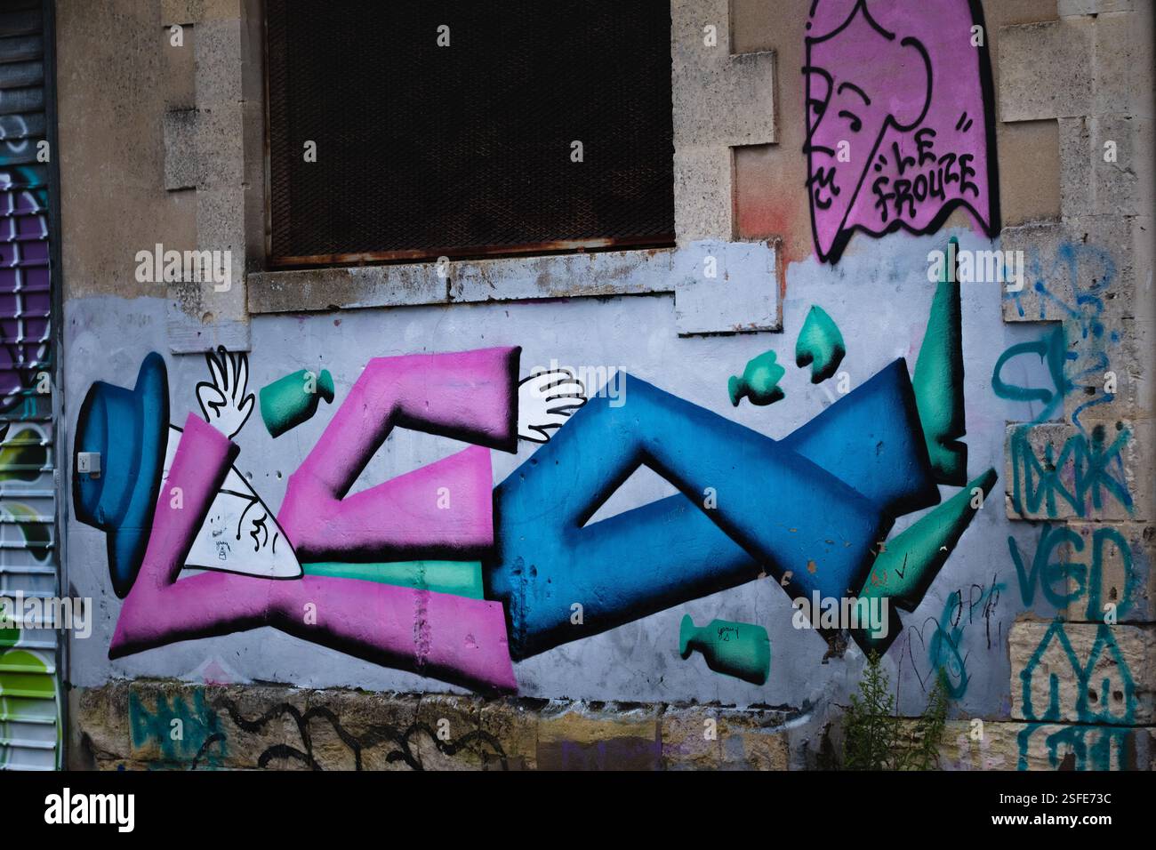 horizontal view of a street art piece representing a man lying down ...