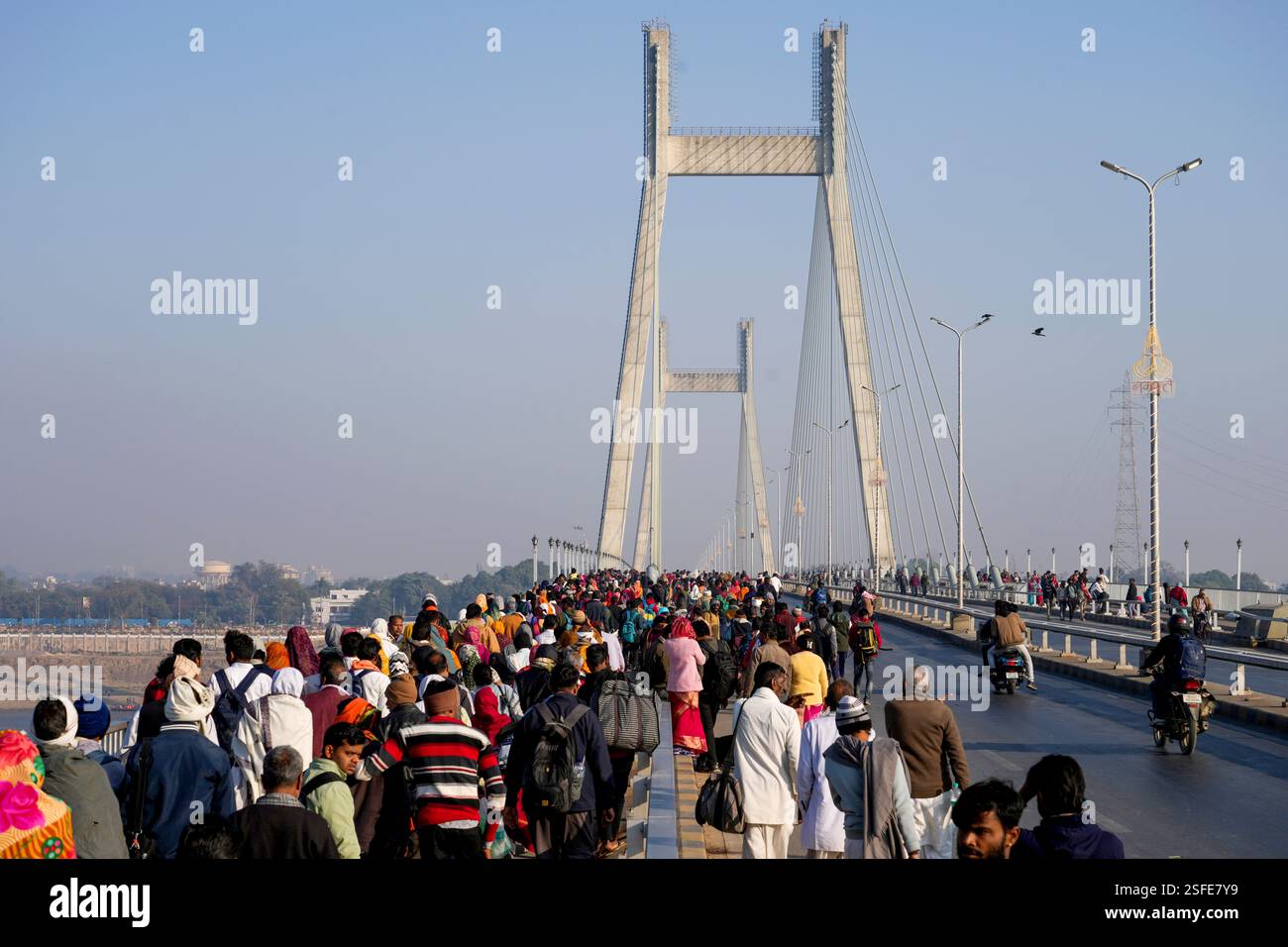 Hindu devotees cross the new Naini bridge during the Mahakumbh festival ...