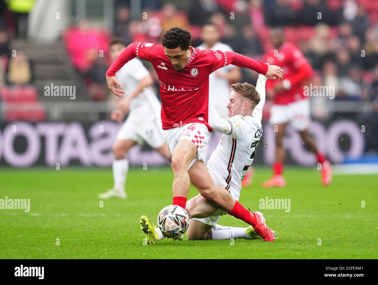 Bristol City's Haydon Roberts (left) is tackled by Swansea City's Ollie ...