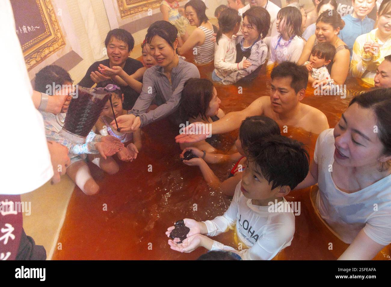Hakone, Japan. 09th Feb, 2025. Bathers enjoy in a chocolate bath at the ...