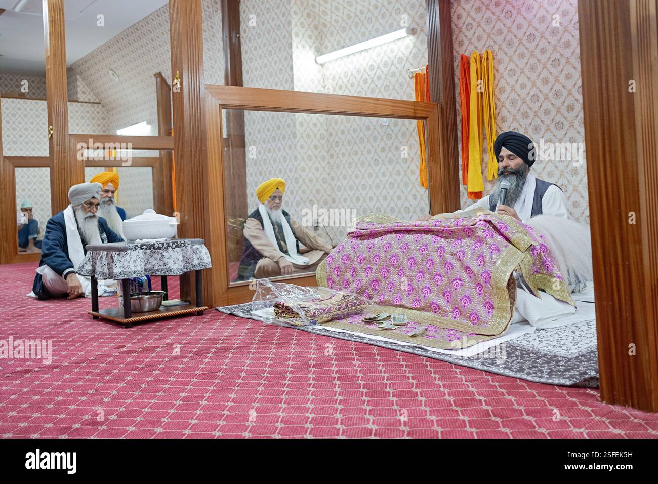 At a morning service a Sikh priest reads the entirety of their bible ...
