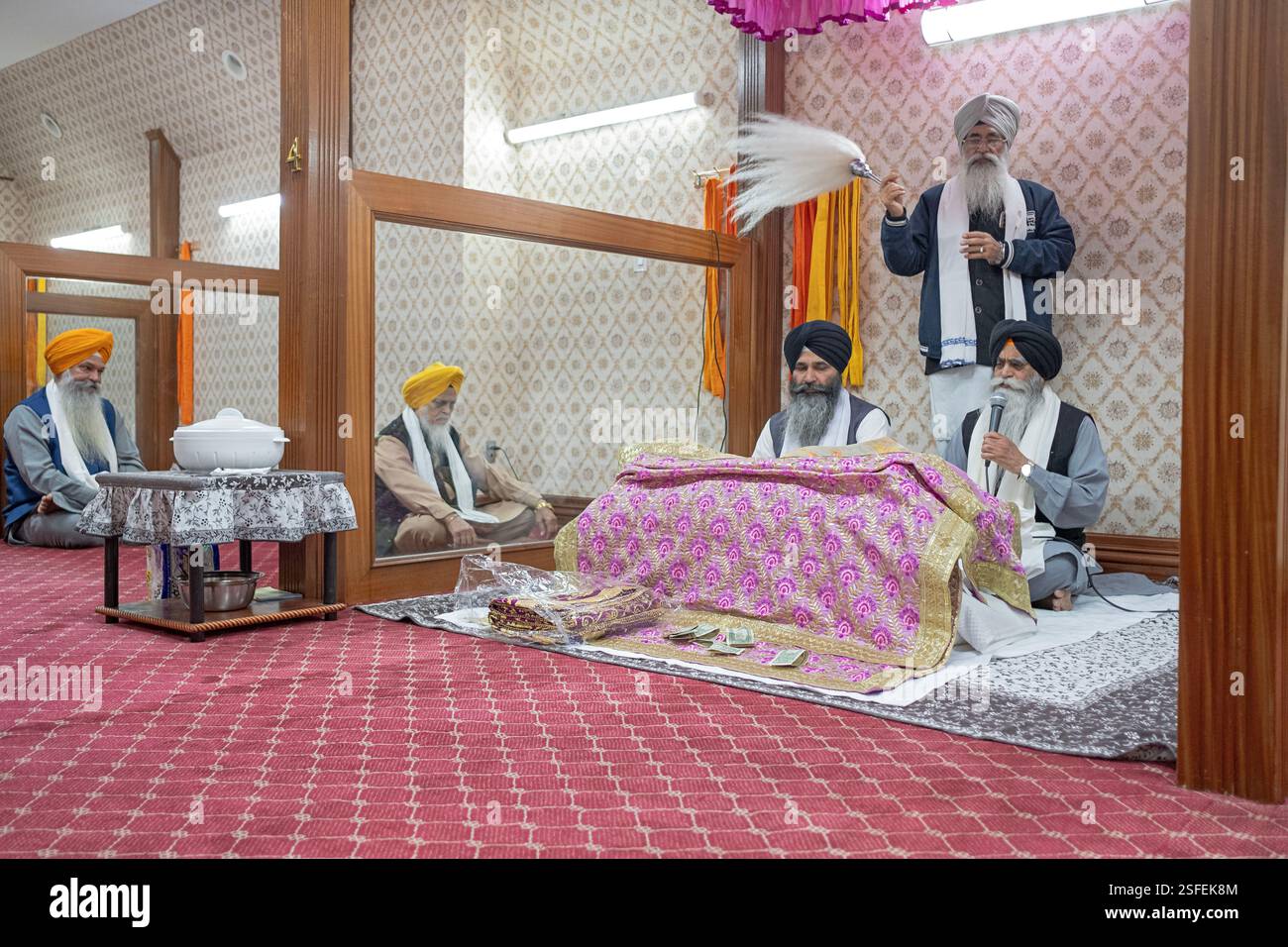 At a morning service in a Sikh temple priests read their holy book Guru ...
