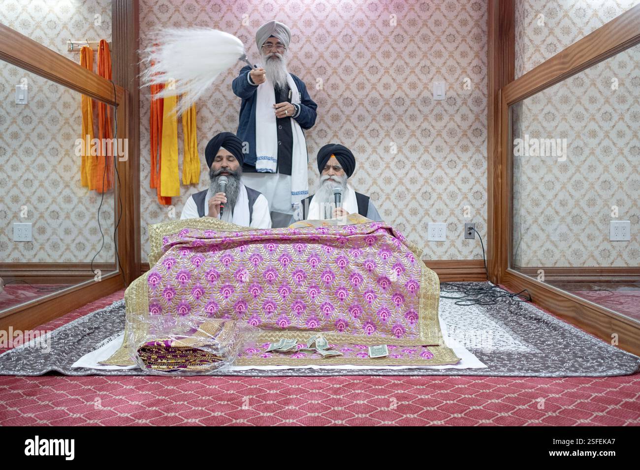 At a morning service in a Sikh temple priests read their holy book Guru ...