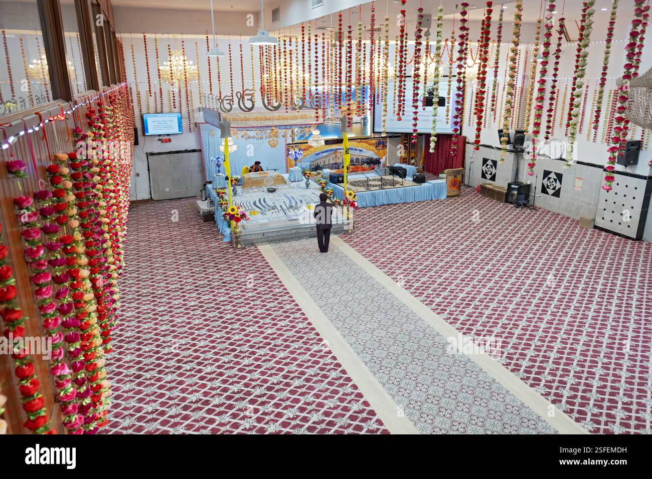 A near empty Sikh temple on a Sunday morning with only a worshipper ...