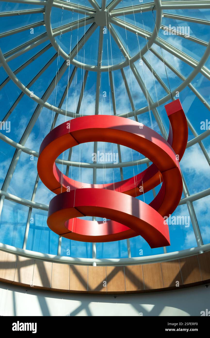 A red curved squiggle sculpture hanging from a dome in the Roosevelt ...