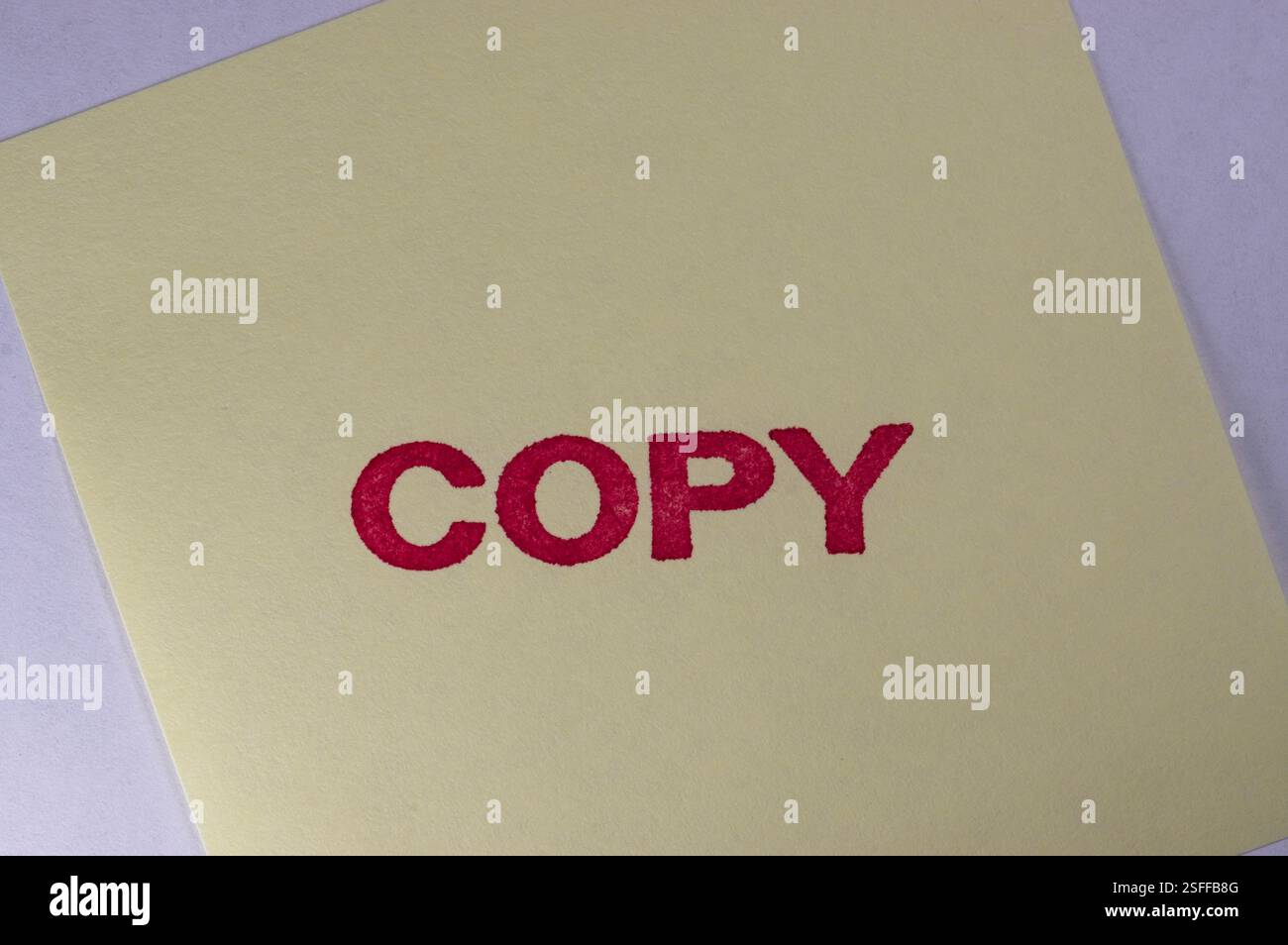 Rubber stamp COPY on yellow sticky note Stock Photo - Alamy