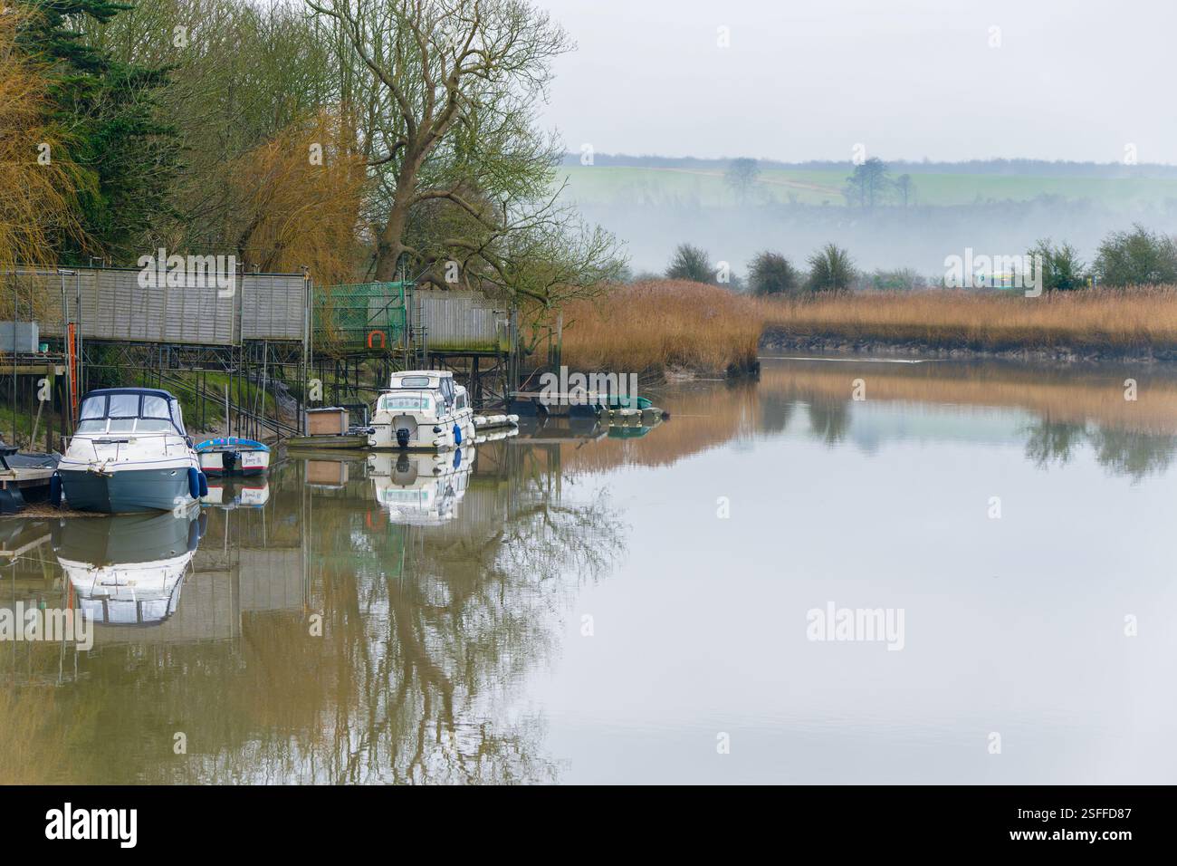 Boats moored along the River Arun during mist., Arundel, West Sussex ...