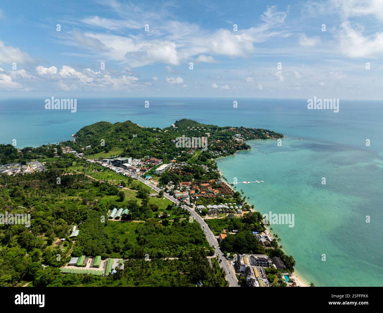 A coastal town with white sands and beach resorts surrounded by ...