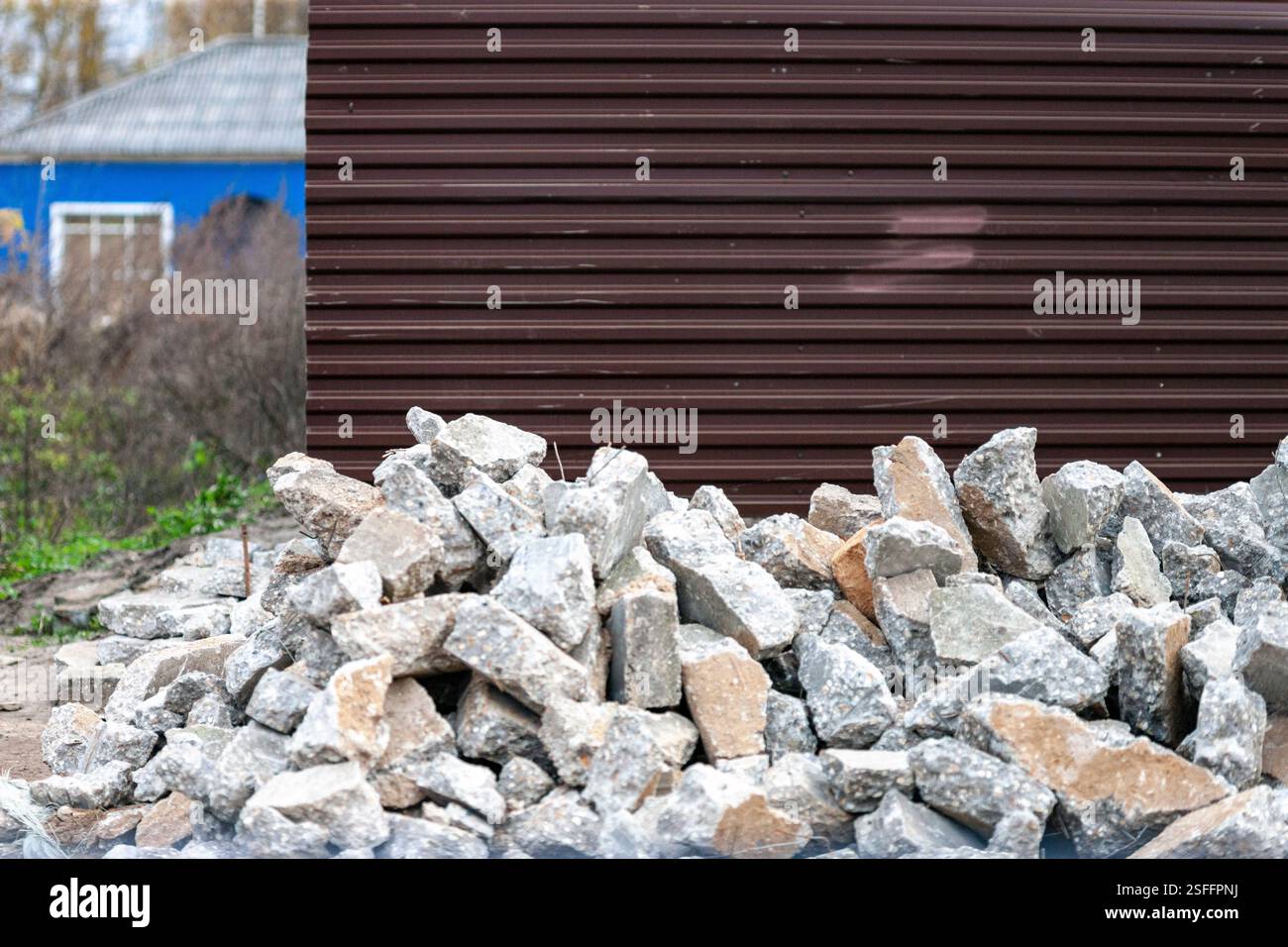 heap of stones offloaded next to the fence, urban scene, no people ...