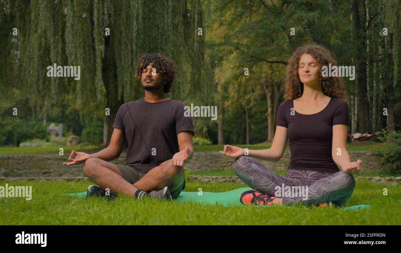 Yoga sport morning meditation multiracial couple Arabian Indian man ...