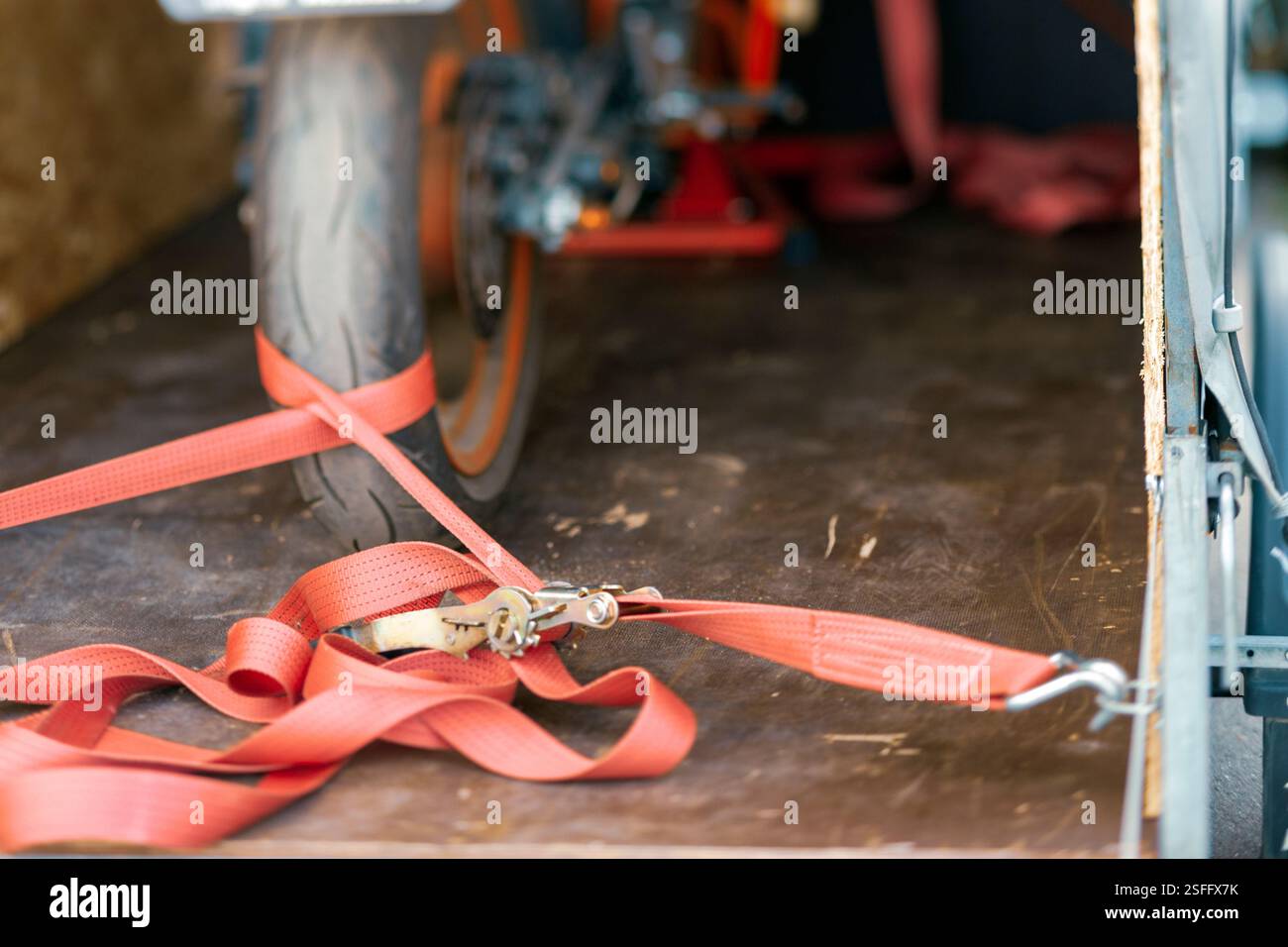 a bike wheel properly strapped and locked in a trailer, tilt shift ...