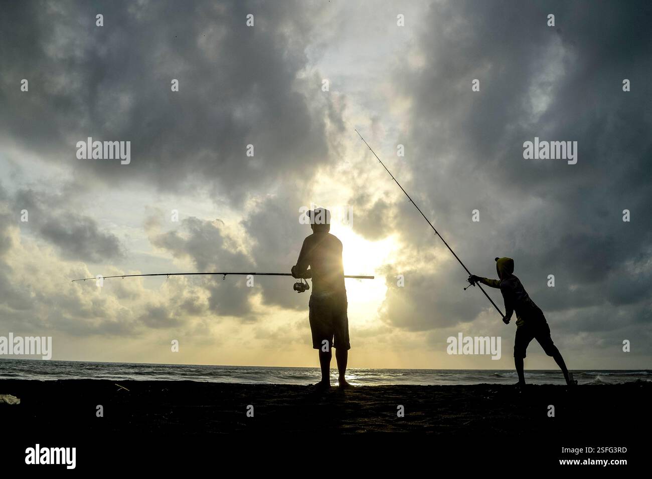 Yogyakarta, Indonesia. 9th Feb, 2025. People fish at sunset on the ...