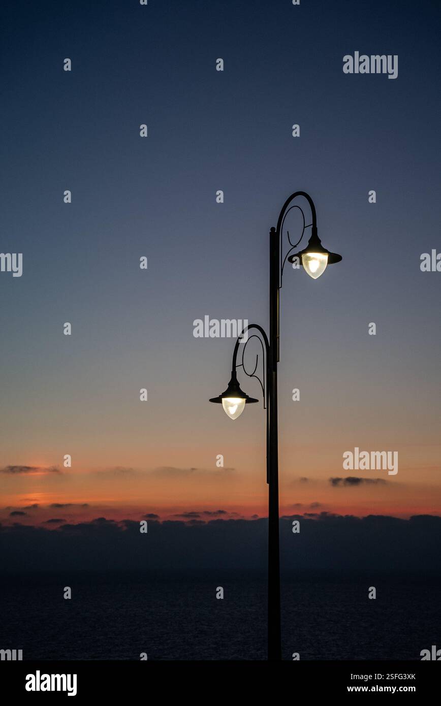 Public street lighting pole with LED lights with sunset color ...
