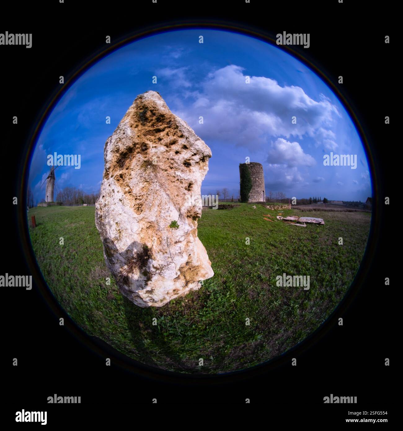 circular fisheye view of an erected stone before old windmills at mound ...