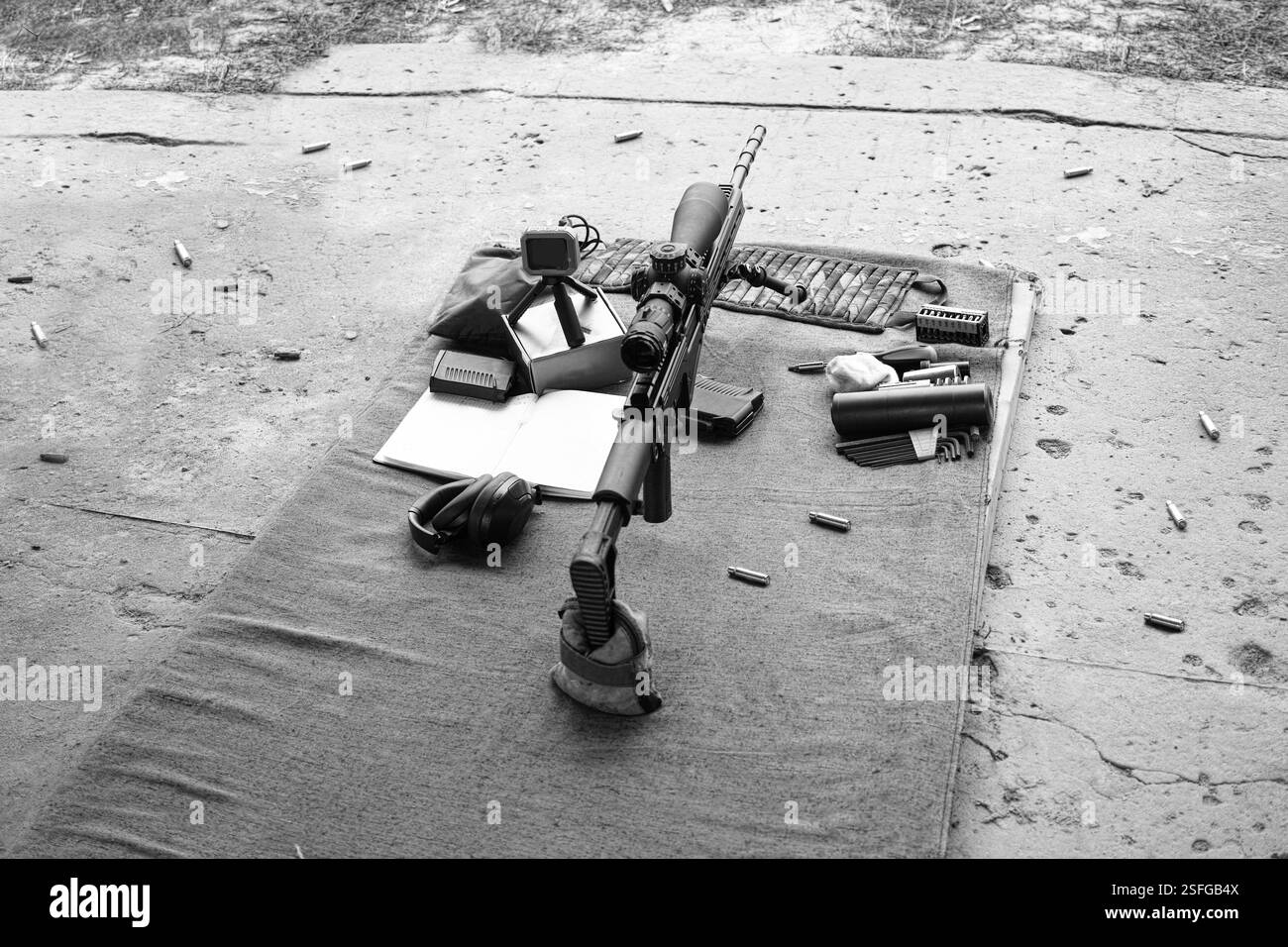 adjustments of a sniper rifle scope on the fire range, in black and ...