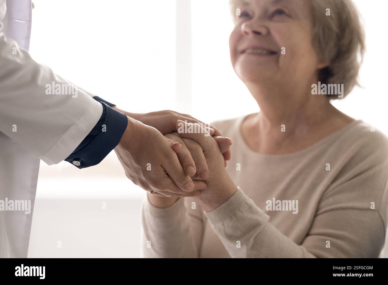Supportive young doctor giving hi-res stock photography and images - Alamy