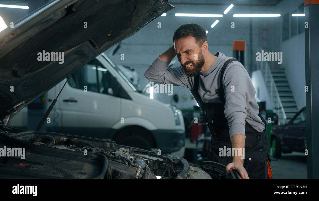Confused shocked Caucasian guy man auto mechanic male repairman open ...