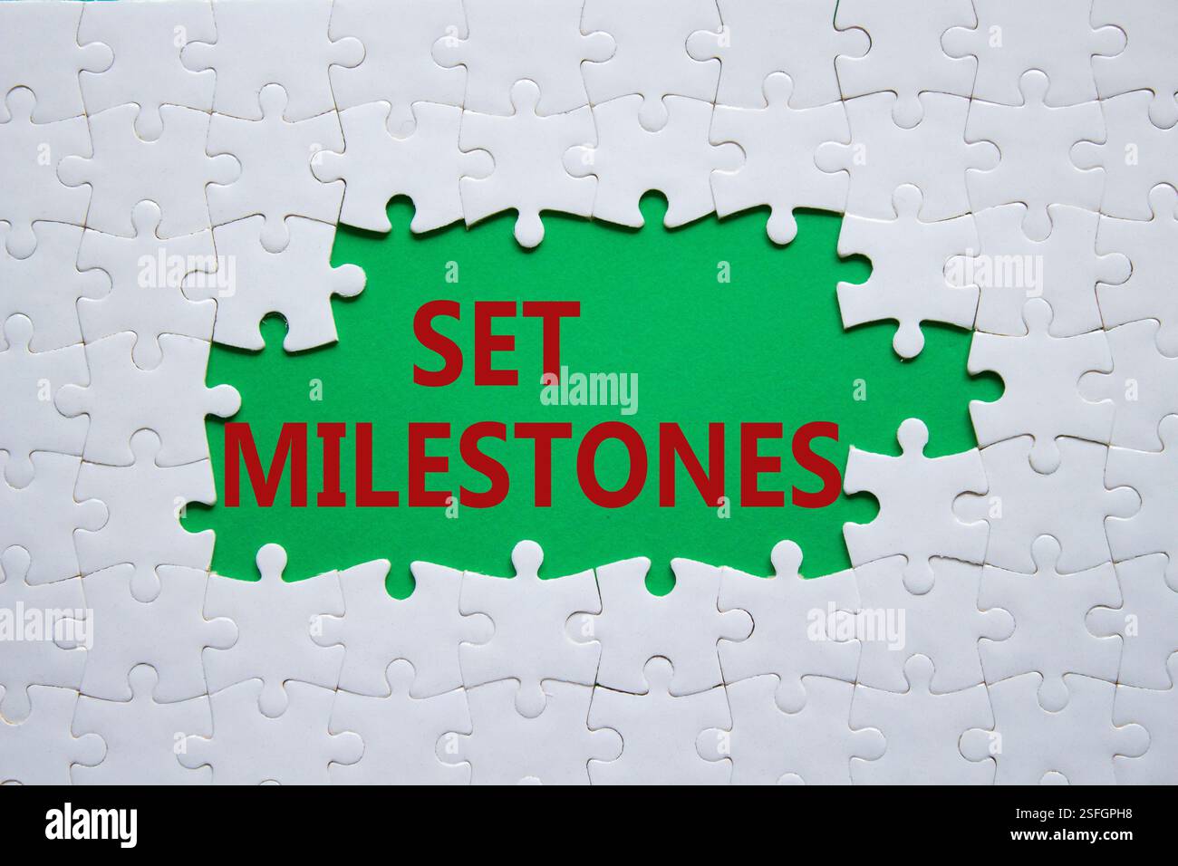 Set milestones symbol. Concept word Set milestones on white puzzle ...