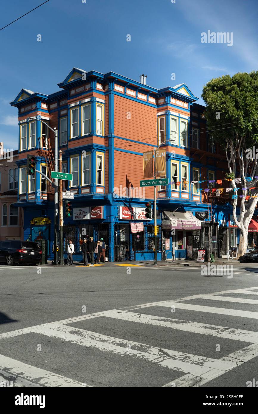Pedestrians cross 24th St & South Van Ness, San Francisco. Colorful ...