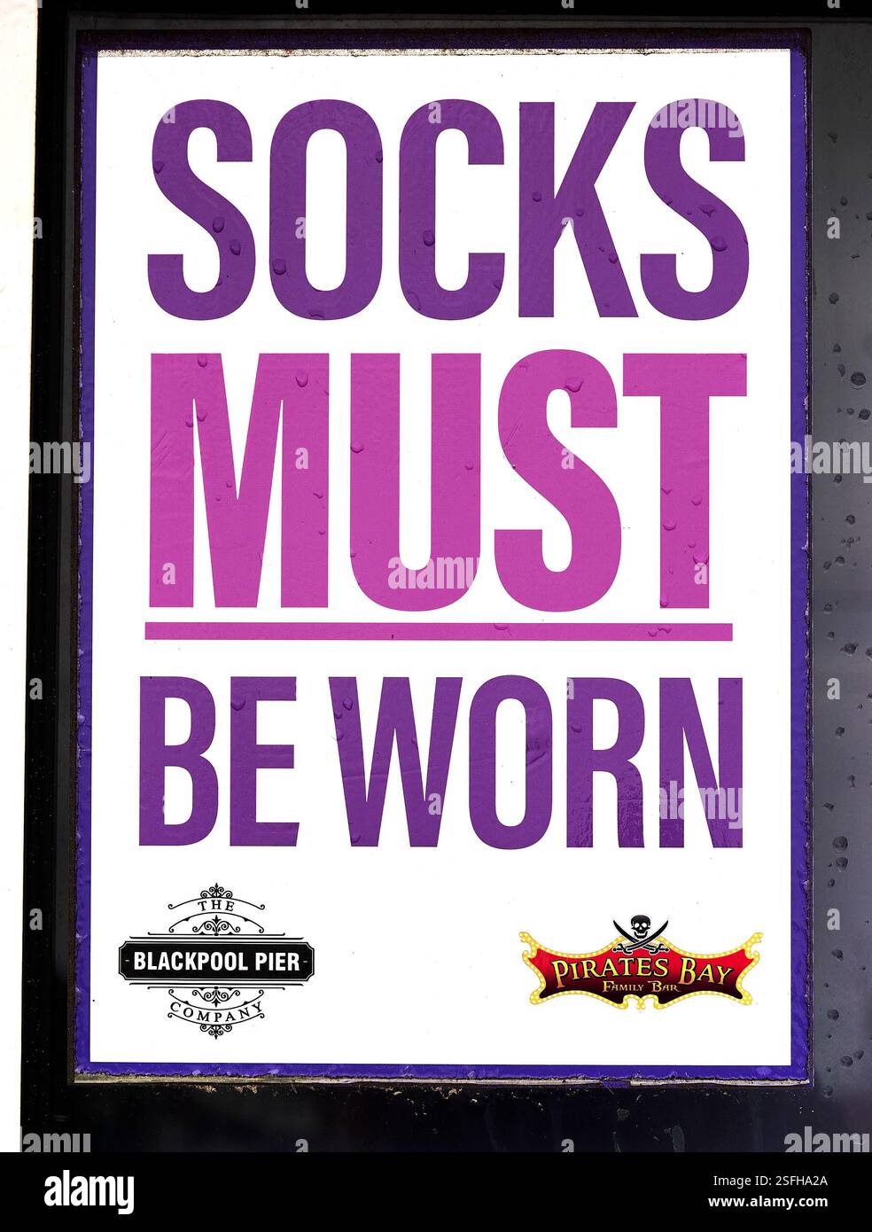Socks must be worn poster on childrens bouncy castle Stock Photo - Alamy