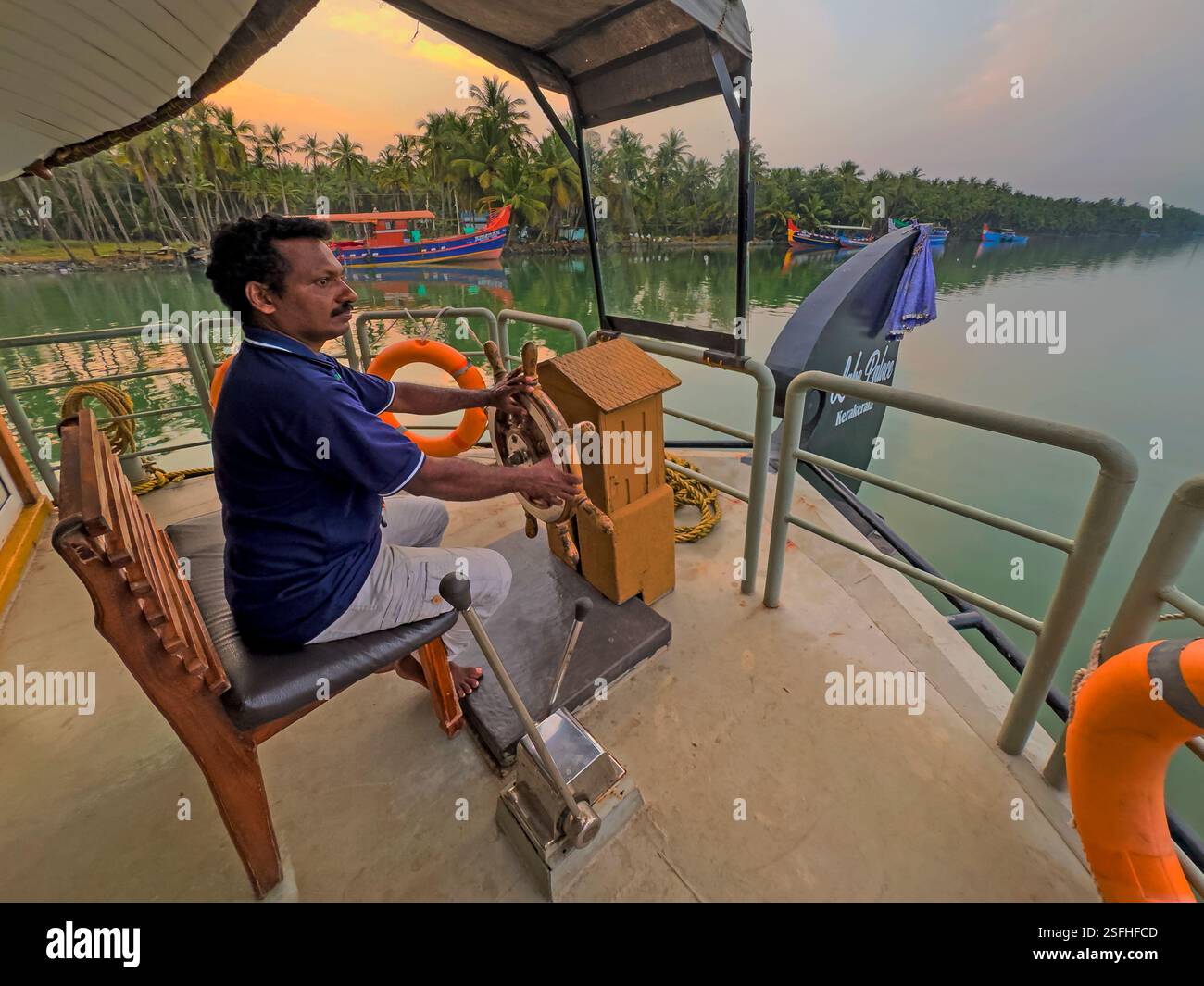 Captain of the Lake Palace houseboat on the Thejaswini River in ...