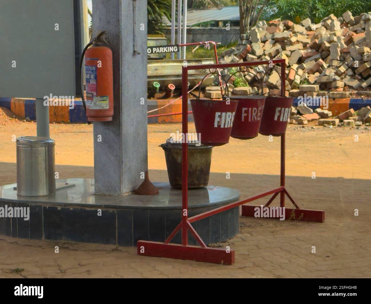 Fire prevention buckets at a gas station in Nileshwar, a village in the ...
