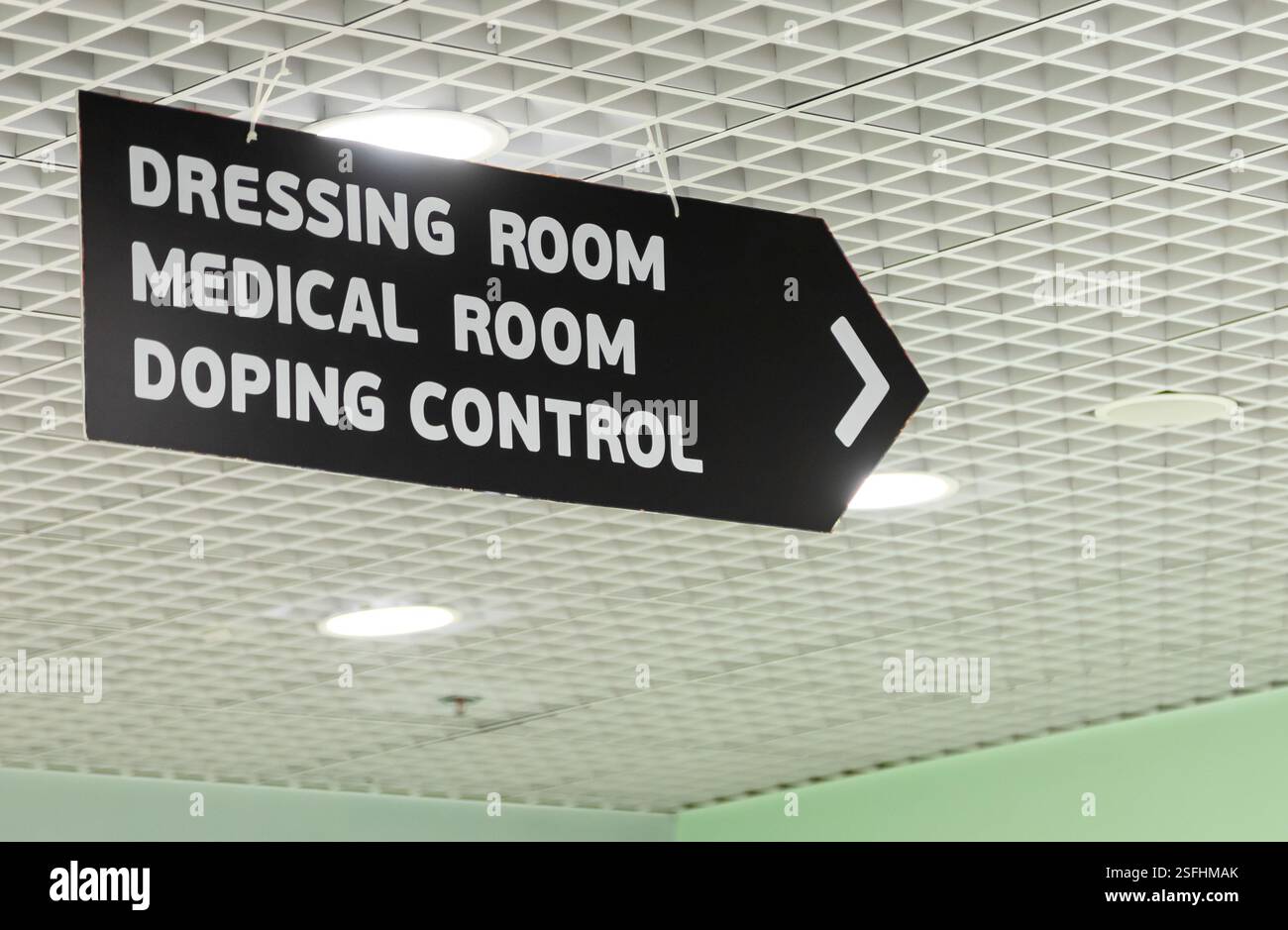 A directional sign indicates the location of the dressing room, medical ...