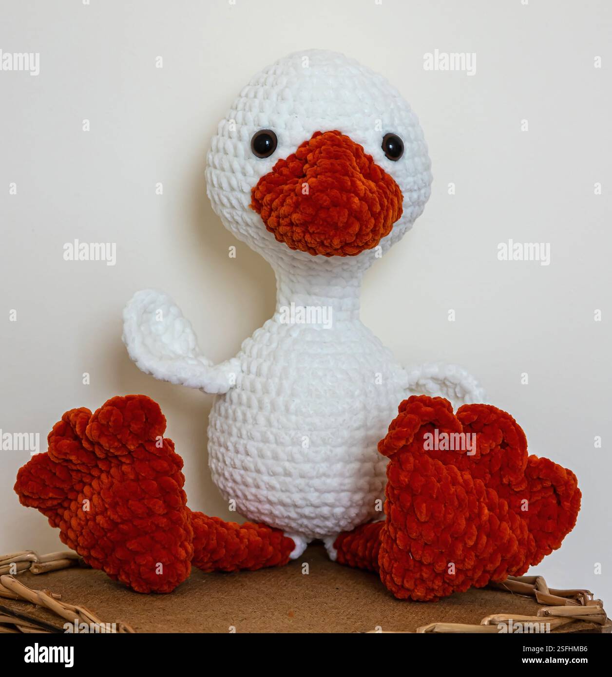 A charming crochet duck featuring a white body and bright orange beak ...