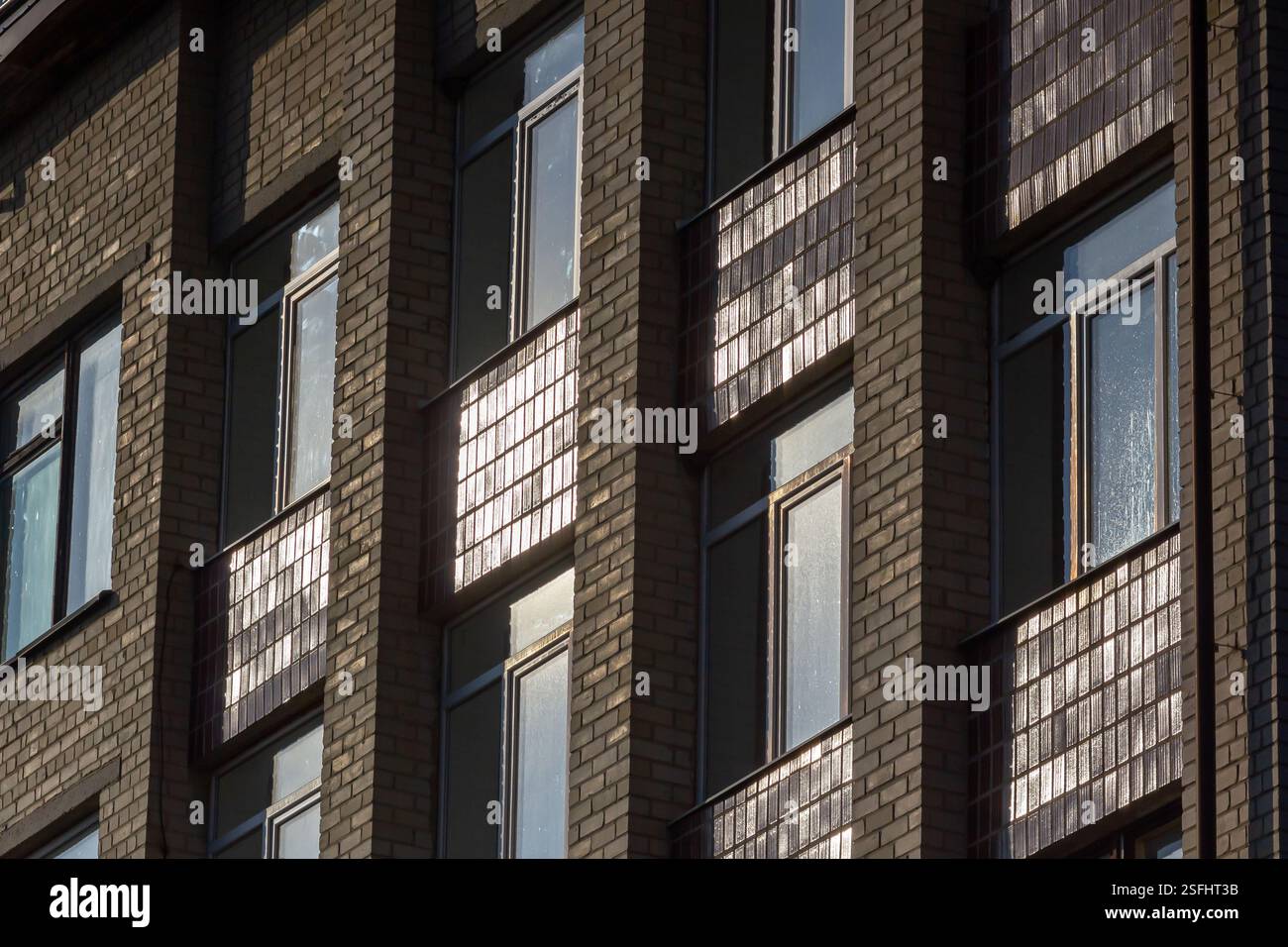 Sunlight bounces off the windows of a contemporary building ...