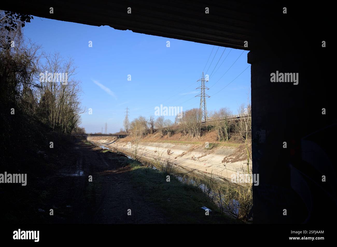 Dirt trail in a park by the edge of a diversionary channel in the ...