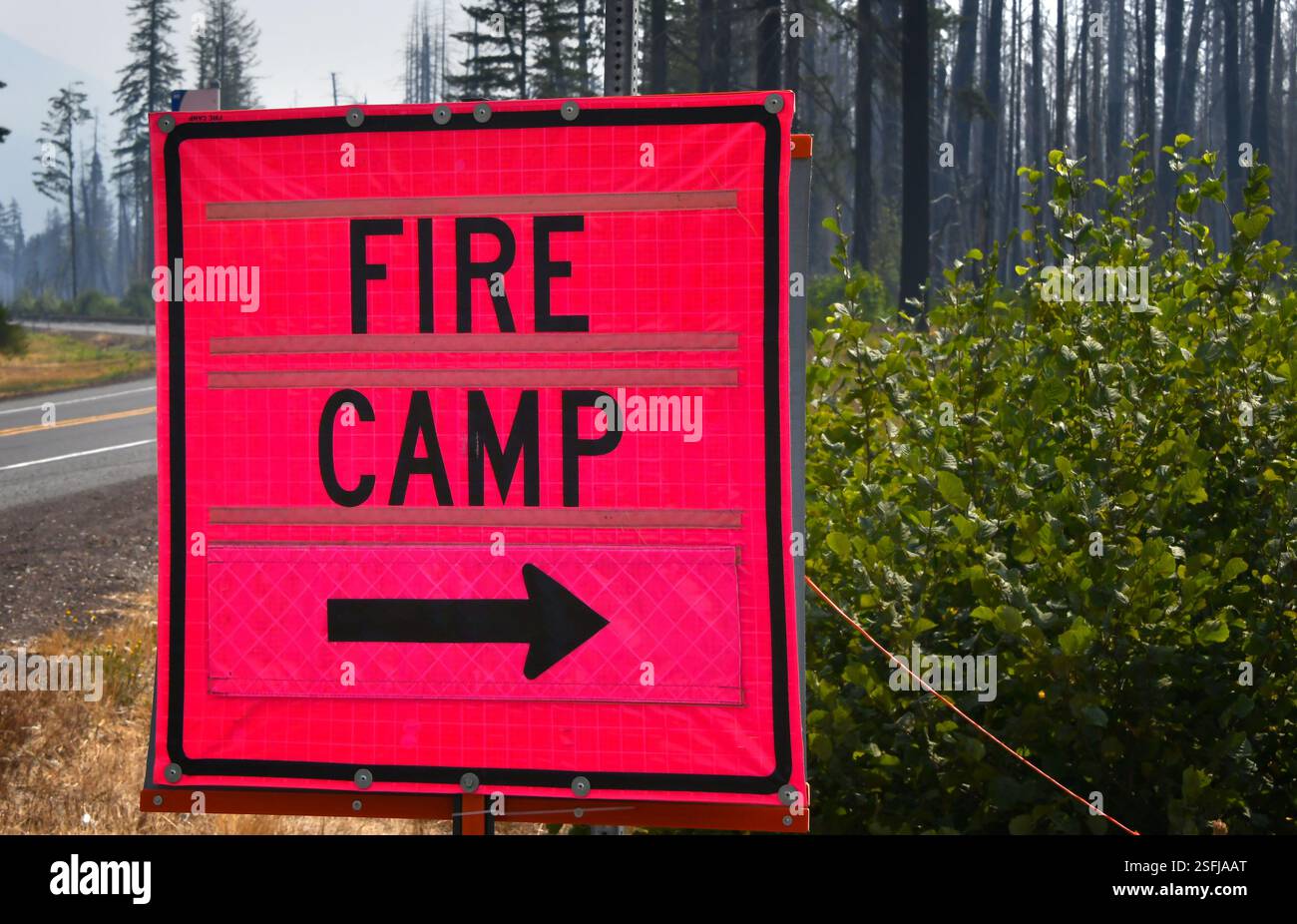 Fabric, sign points way to a fire camp in Oregon. colorful sign says ...